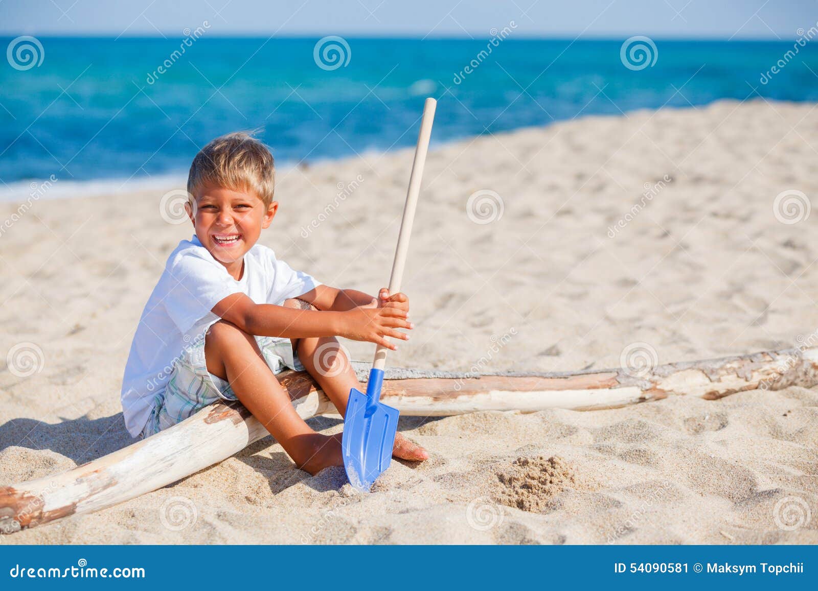 Boy playing on the beach stock image. Image of cheerful - 54090581