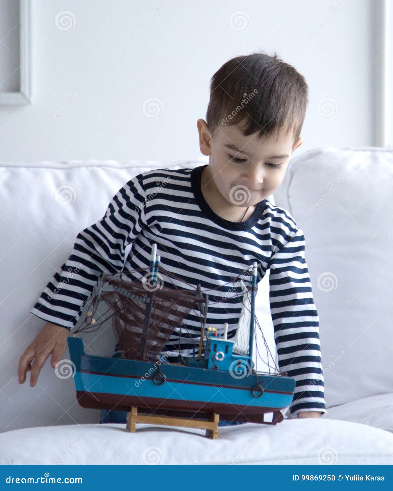 Boy playing with a boat stock photo. Image of romantic - 99869250