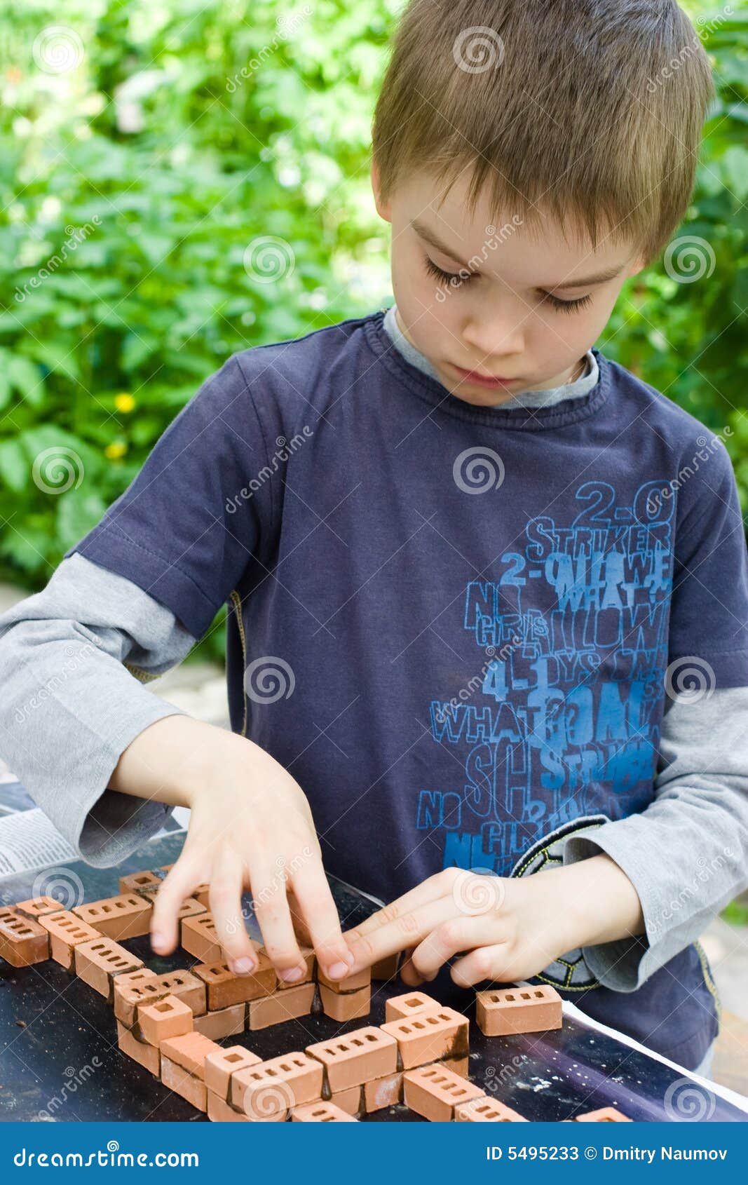 Boy playing with bricks stock image. Image of brick, engineer - 5495233