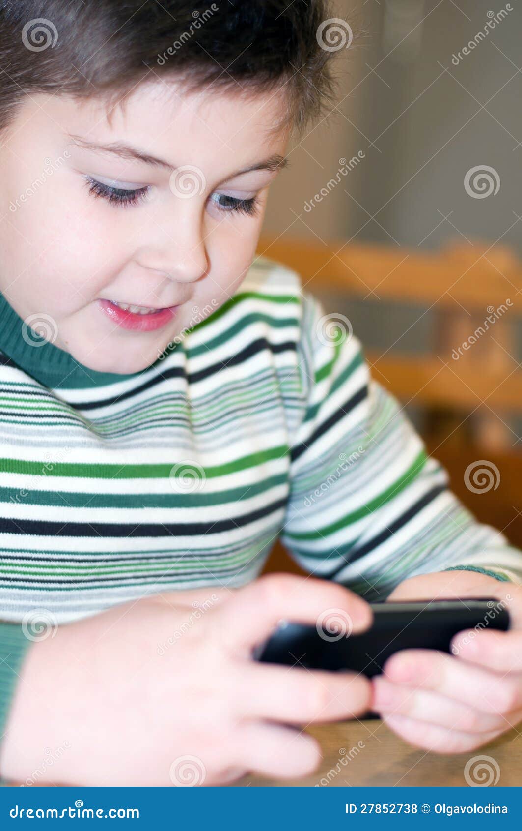 Boy playing on cell phone stock photo. Image of home - 27852738