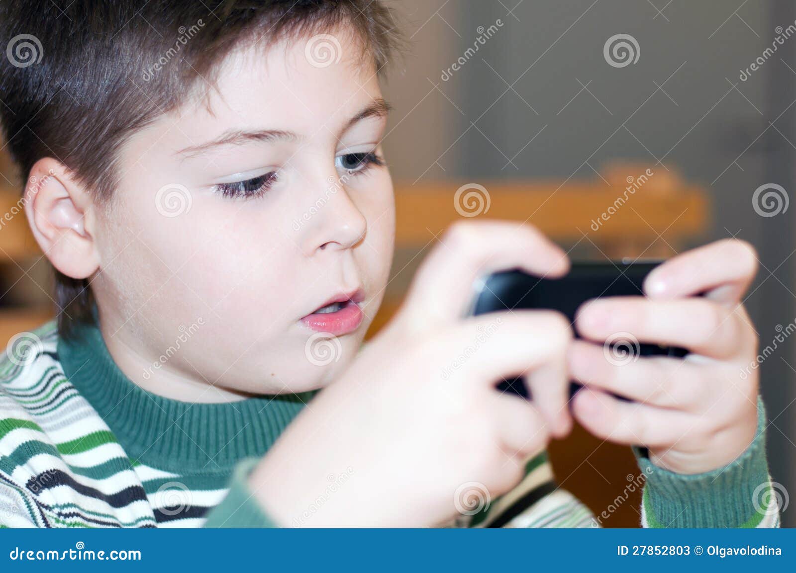 Boy playing on cell phone stock image. Image of years - 27852803