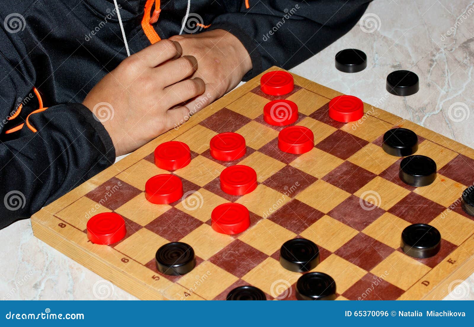 Boy is playing checkers stock photo. Image of mind, recreation - 65370096