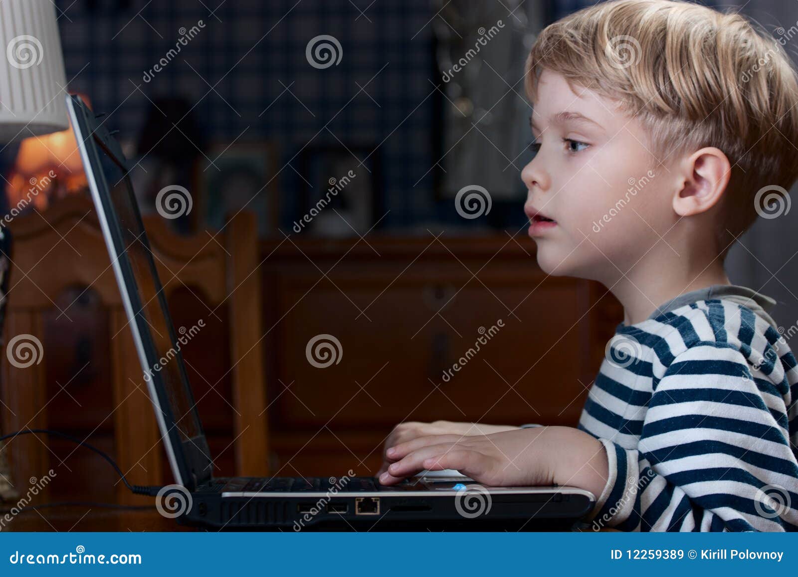Boy playing computer game stock image. Image of notebook - 12259389