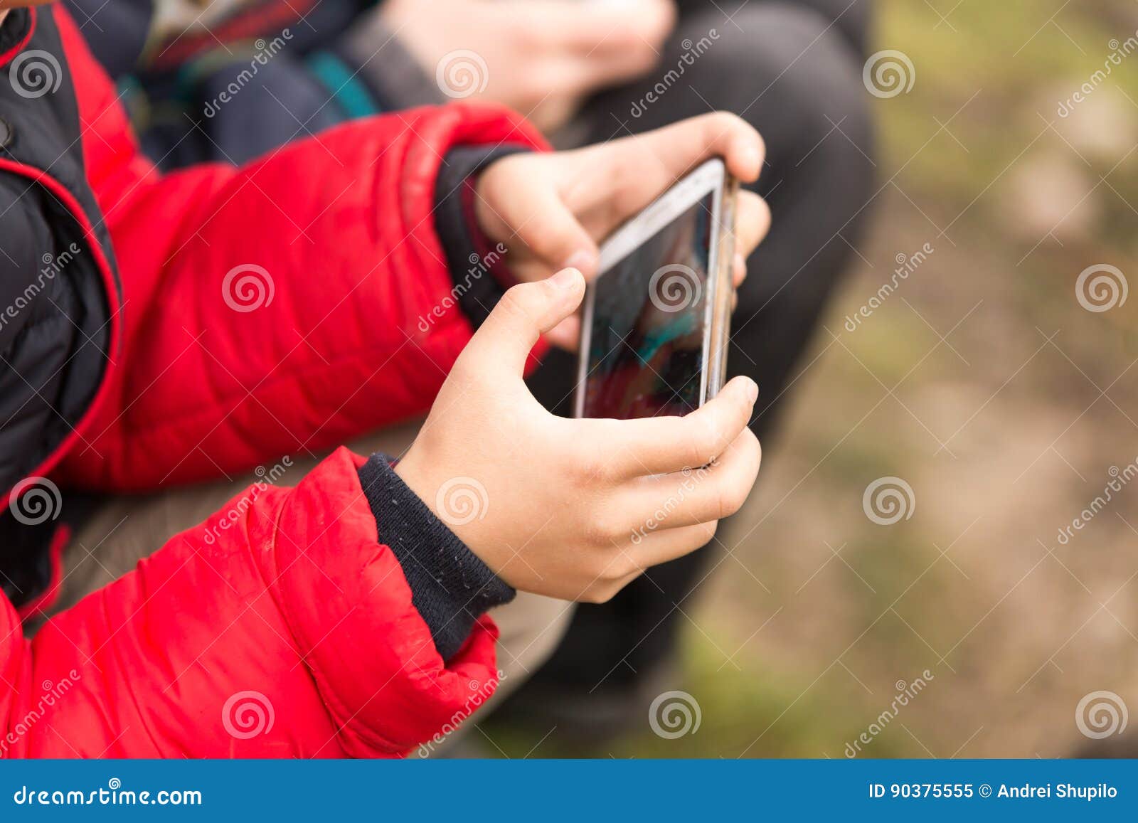 Boy Playing Computer Games on a Cell Phone Stock Image - Image of ...