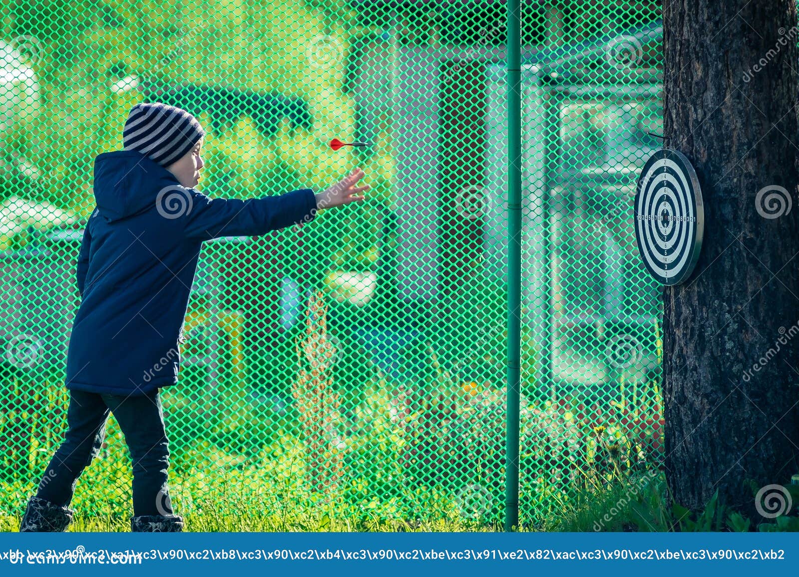 Boy playing darts outdoors stock photo. Image of fling - 96027286