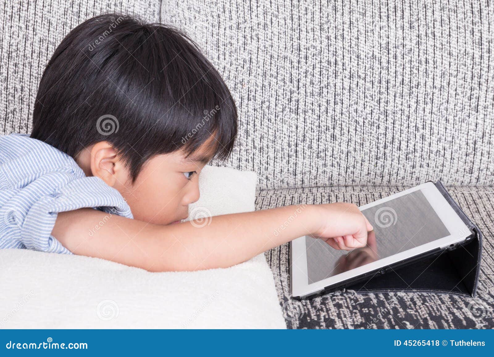 Boy playing digital tablet stock photo. Image of room - 45265418