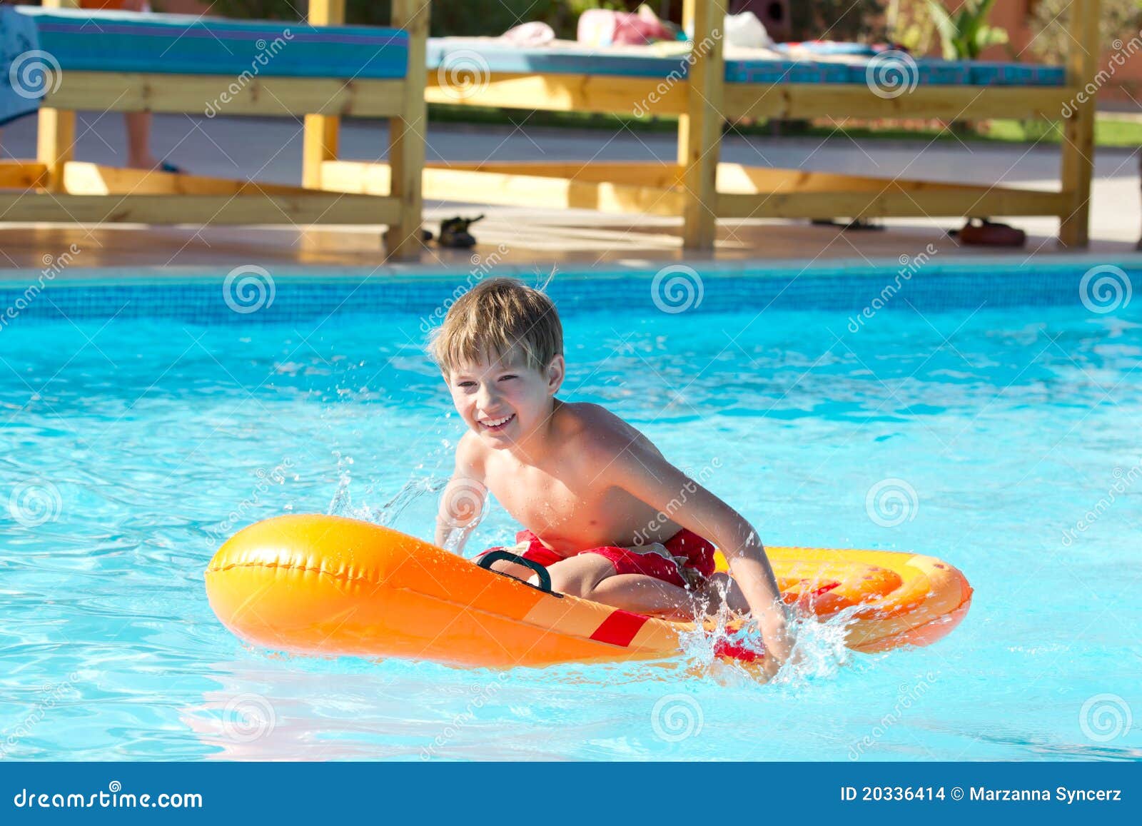 Boy Playing on Dingy in Pool Stock Photo - Image of active, lovable ...