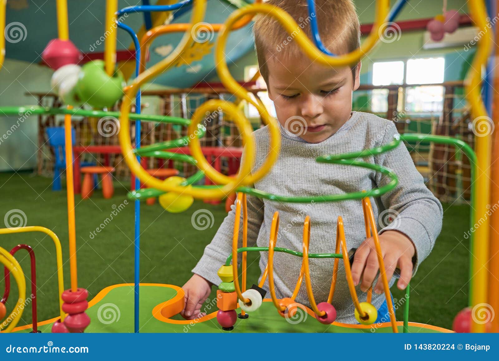 Boy is Playing Educational Toy for Brain Development at Kids Room Stock ...