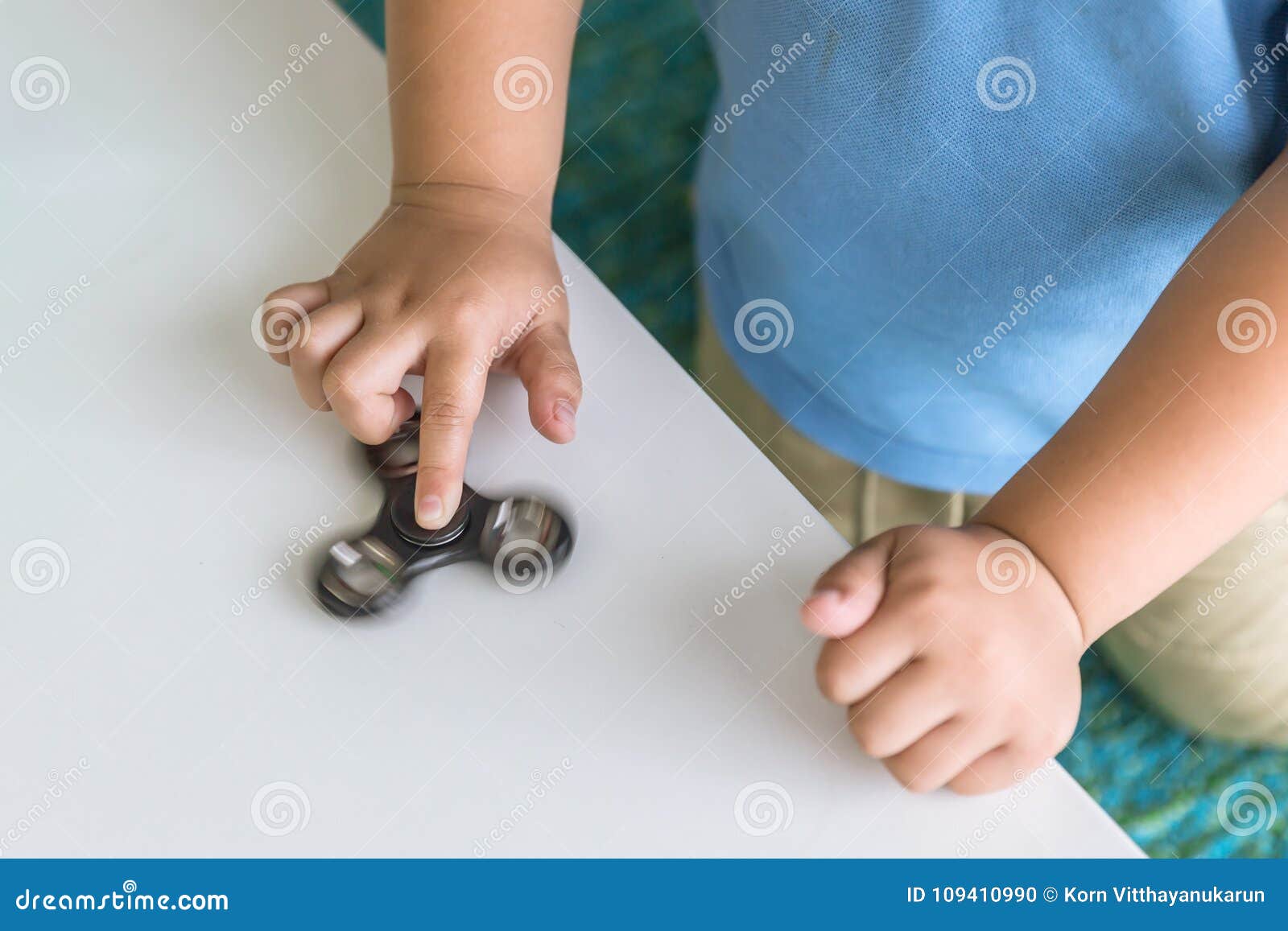 Boy Playing Fidget Spinners Stock Photo - Image of copper, energy ...