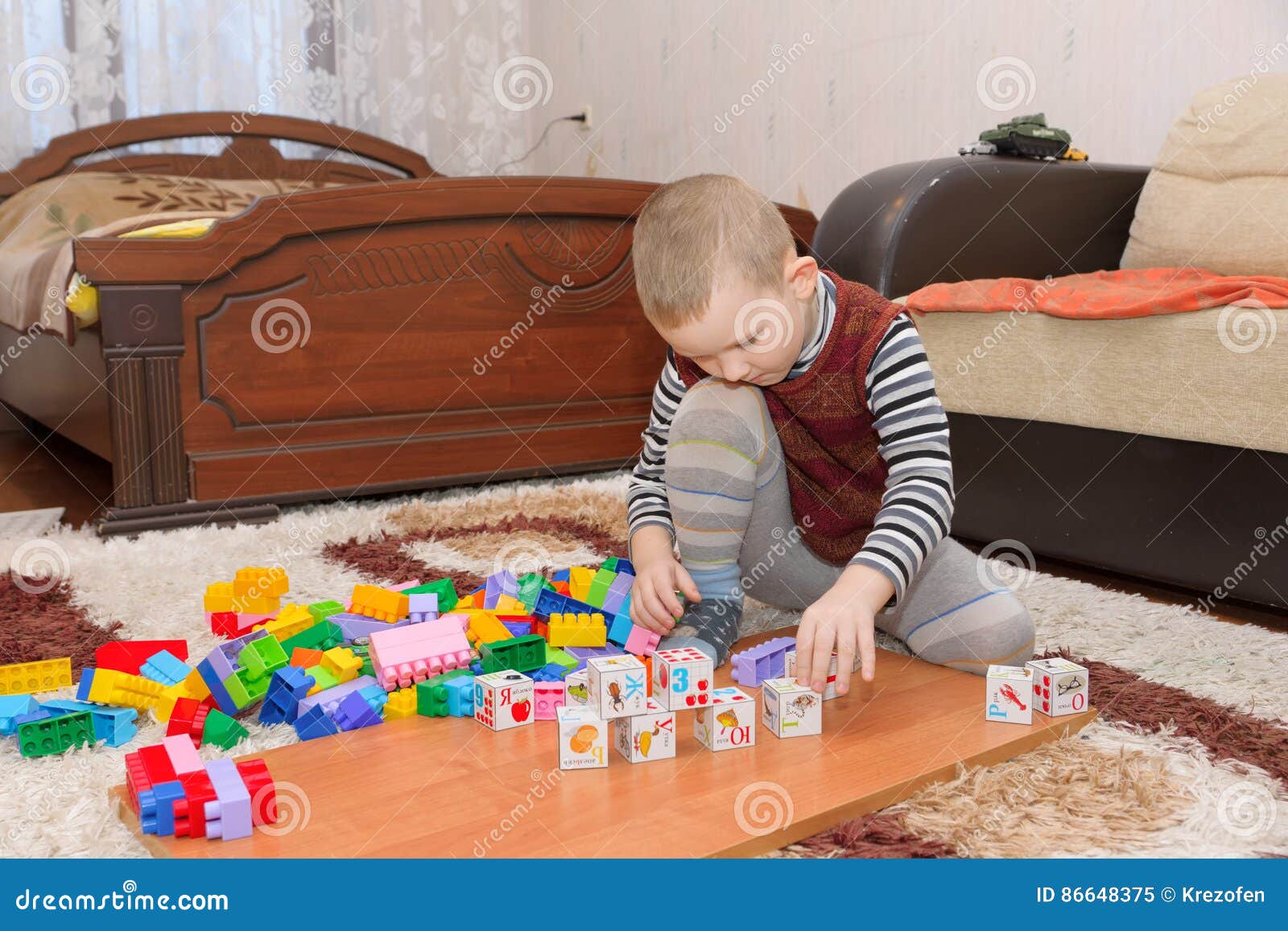 Boy playing on the floor stock image. Image of activity - 86648375