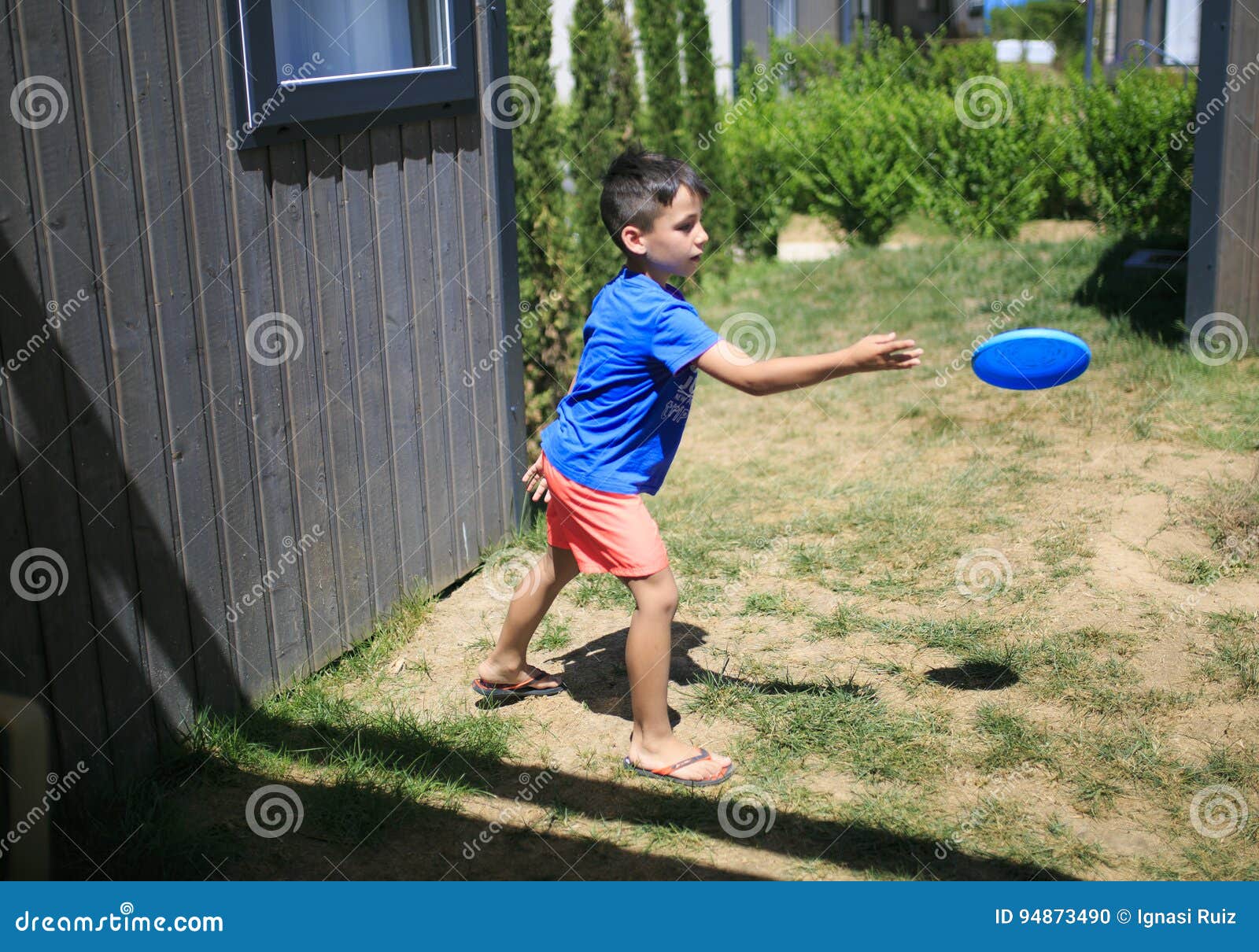 Boy playing with a frisbee stock photo. Image of park - 94873490