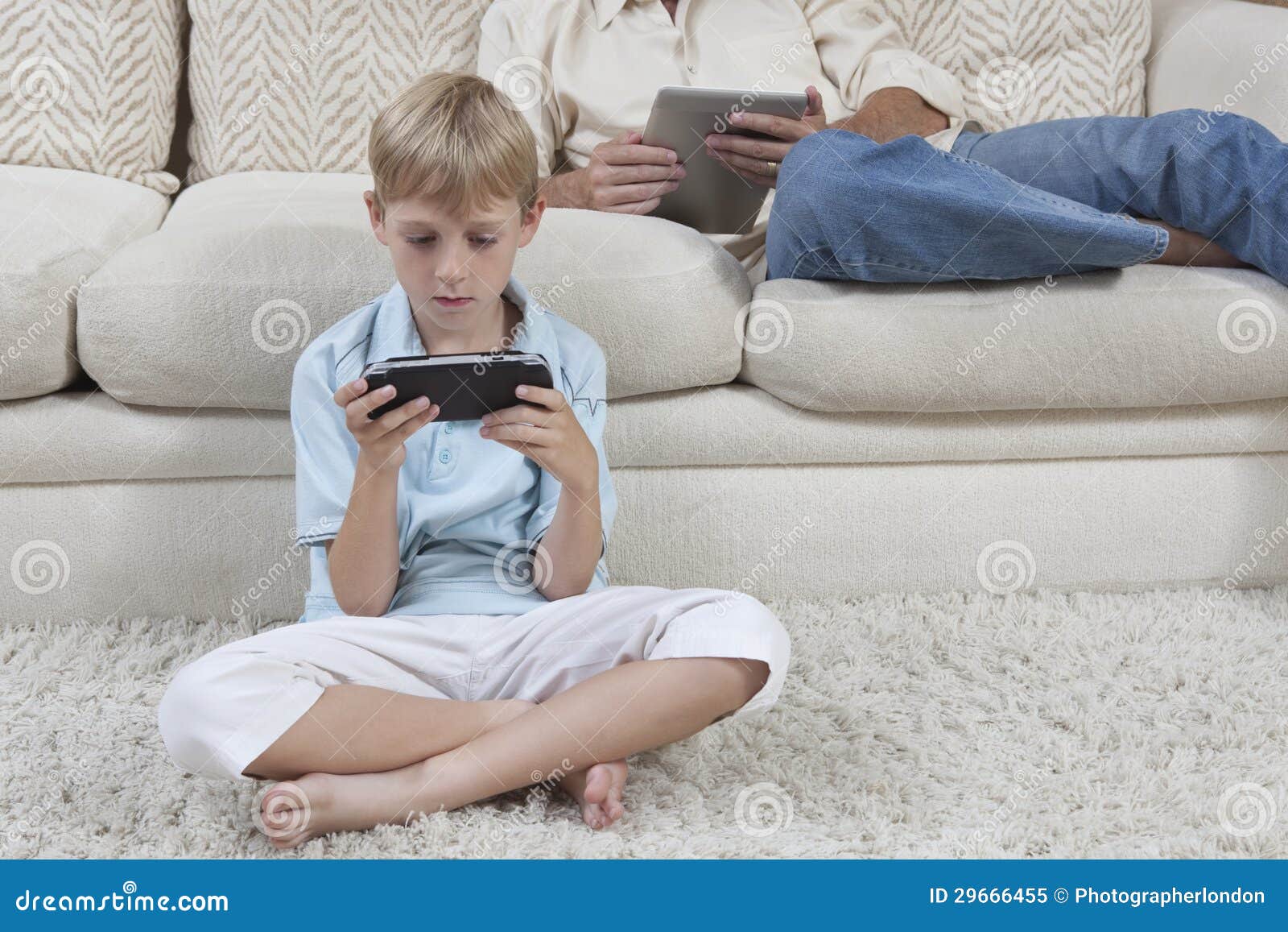Boy Playing Games on PSP stock image. Image of couch - 29666455