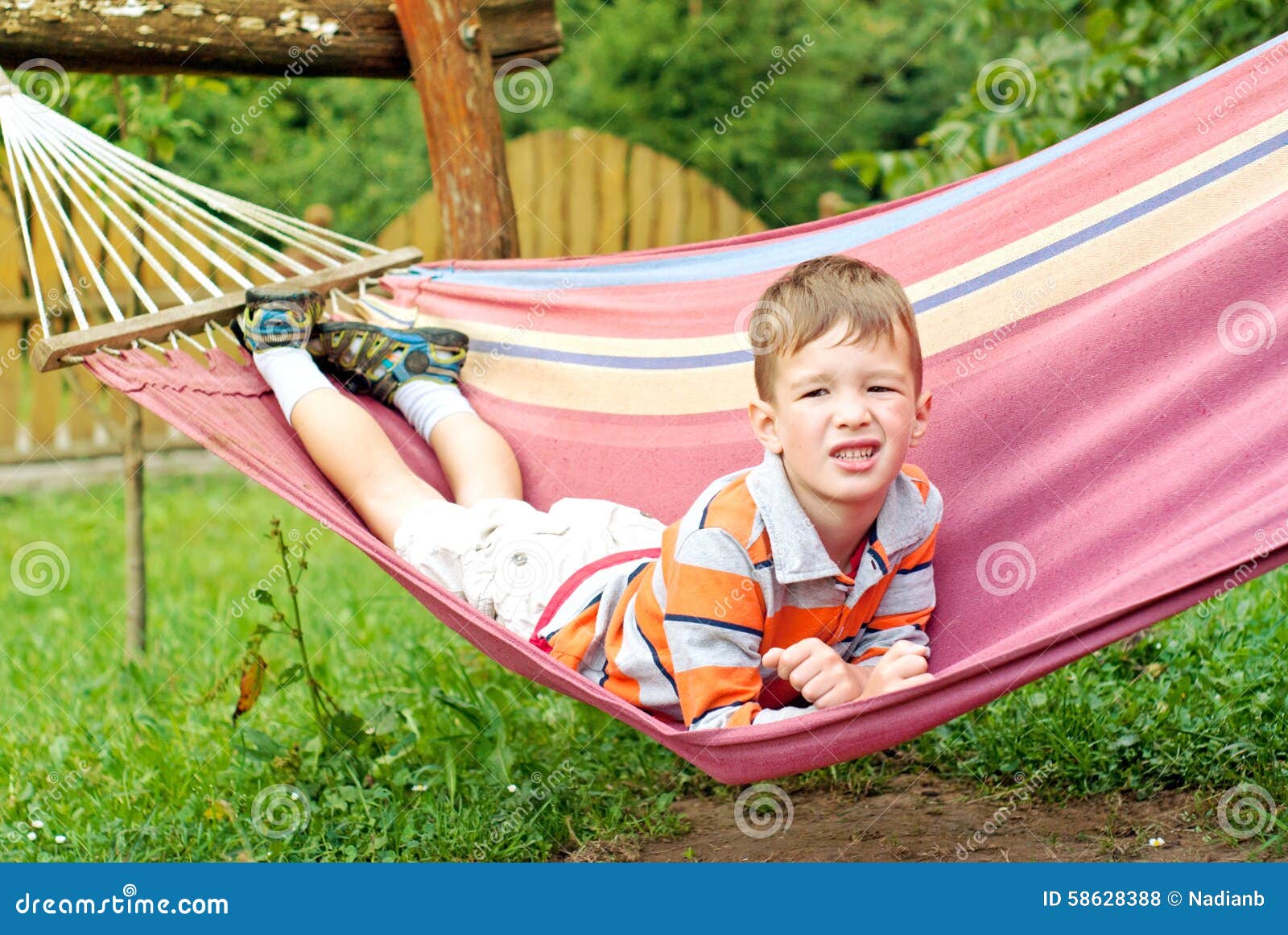 Boy playing in a hammock stock photo. Image of green - 58628388