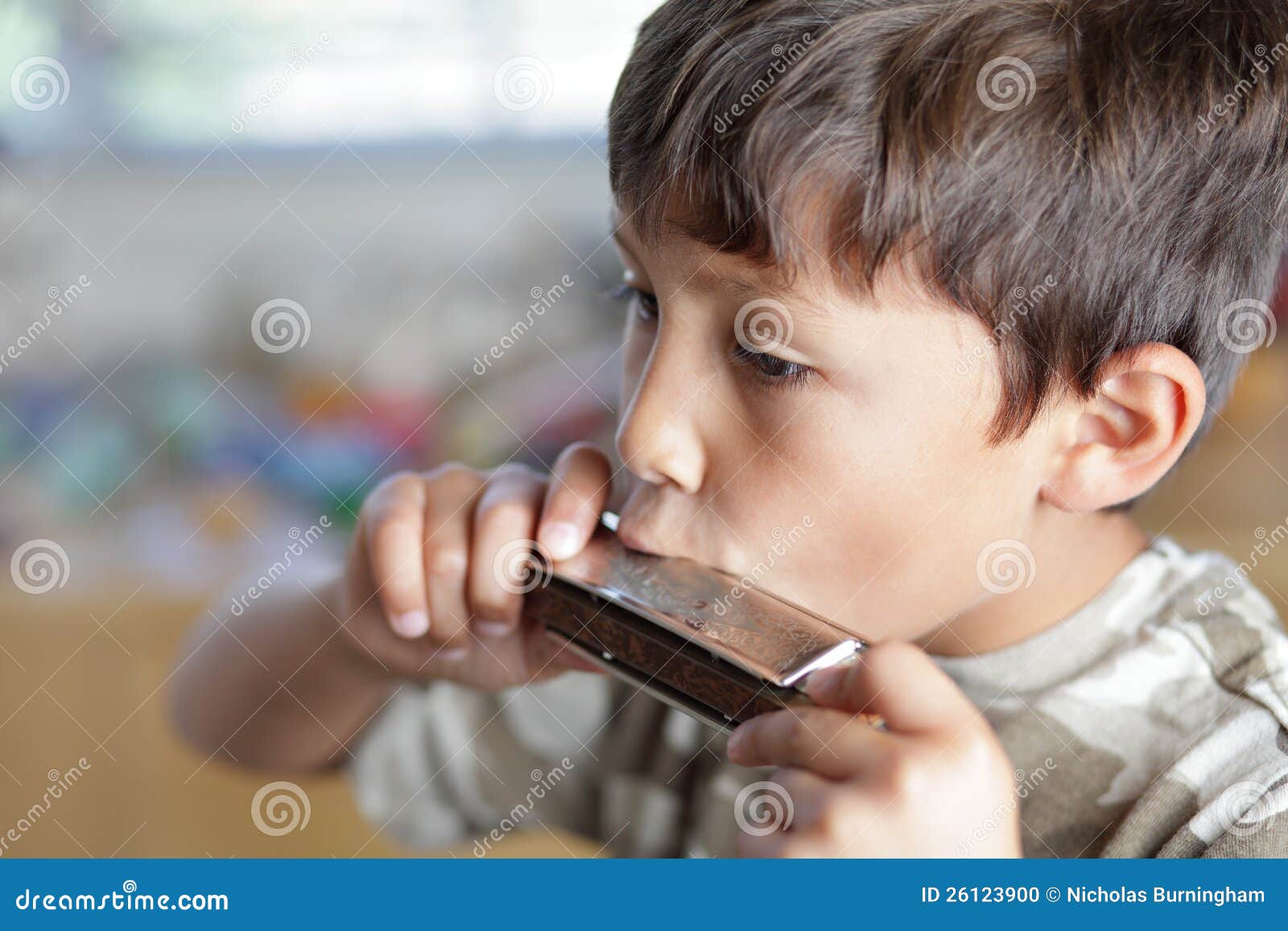 Boy playing with harmonica stock photo. Image of playing - 26123900