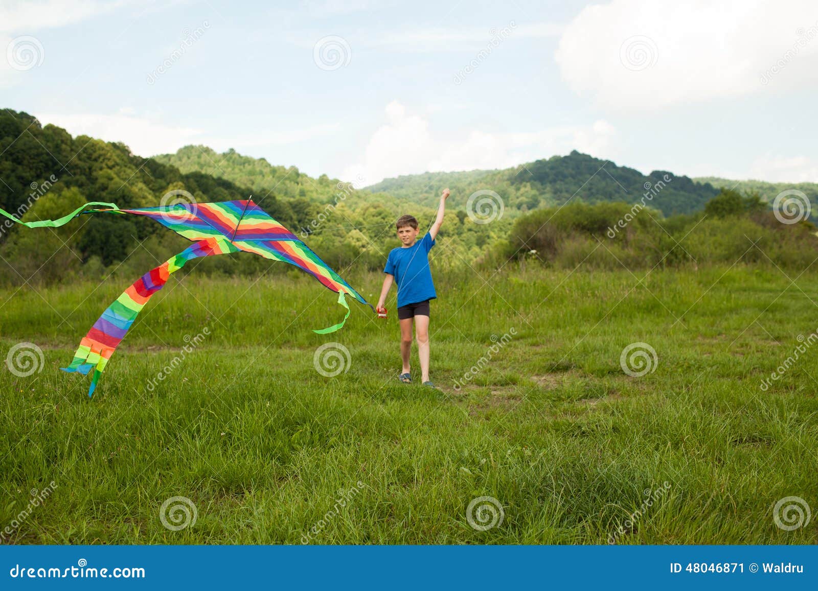 Boy playing with kite stock image. Image of grass, front - 48046871