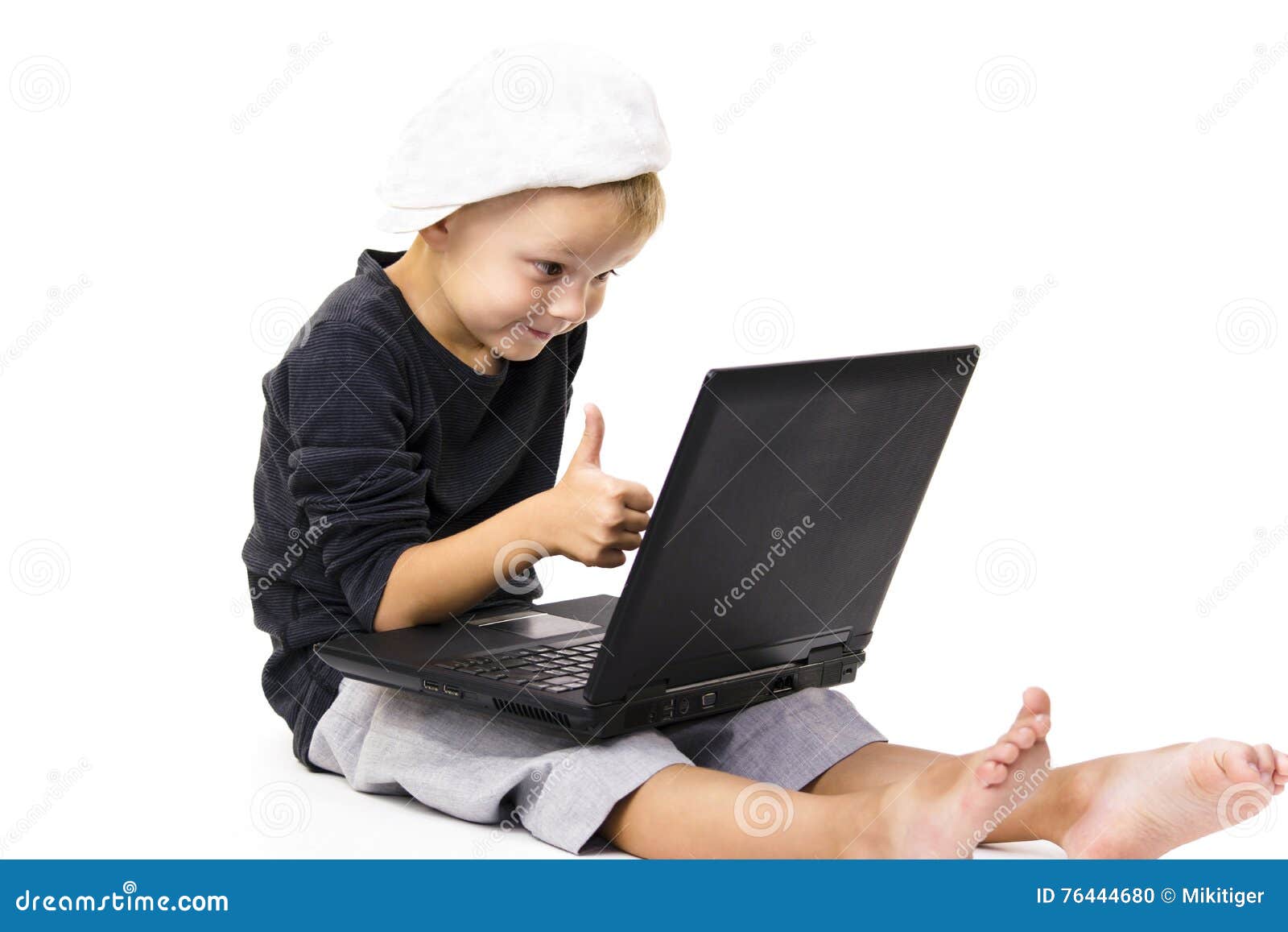 Boy playing laptop stock photo. Image of original, background - 76444680
