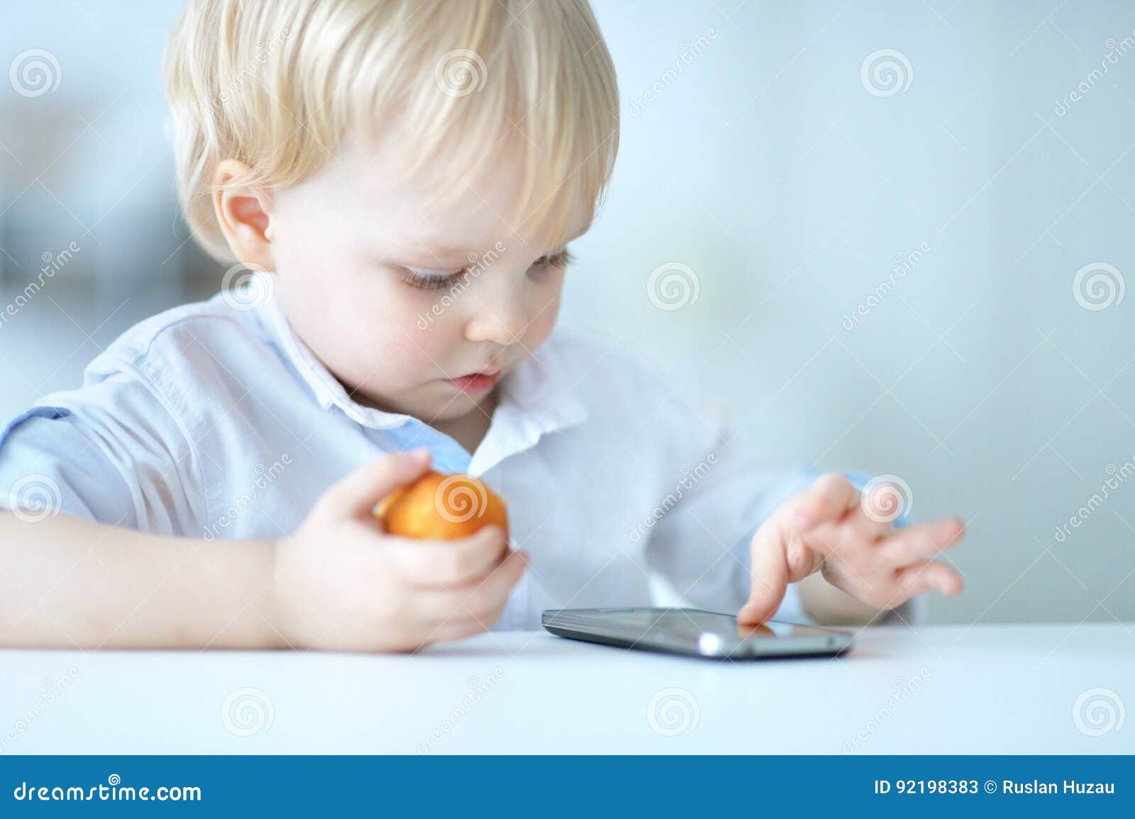 Boy is Playing with a Mobile Phone Stock Image - Image of face ...