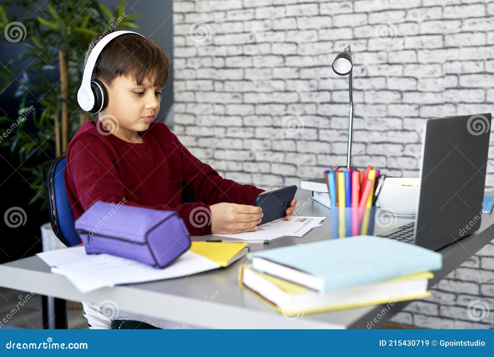 Boy Playing on the Mobile Phone during Online Classes Stock Image ...