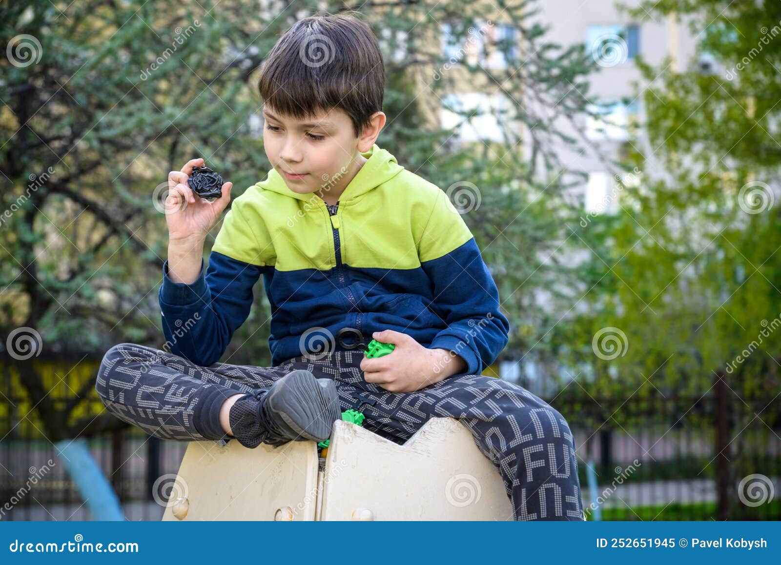 Boy Playing with Modern Spin Top Outdoors. Entertainment Game for ...