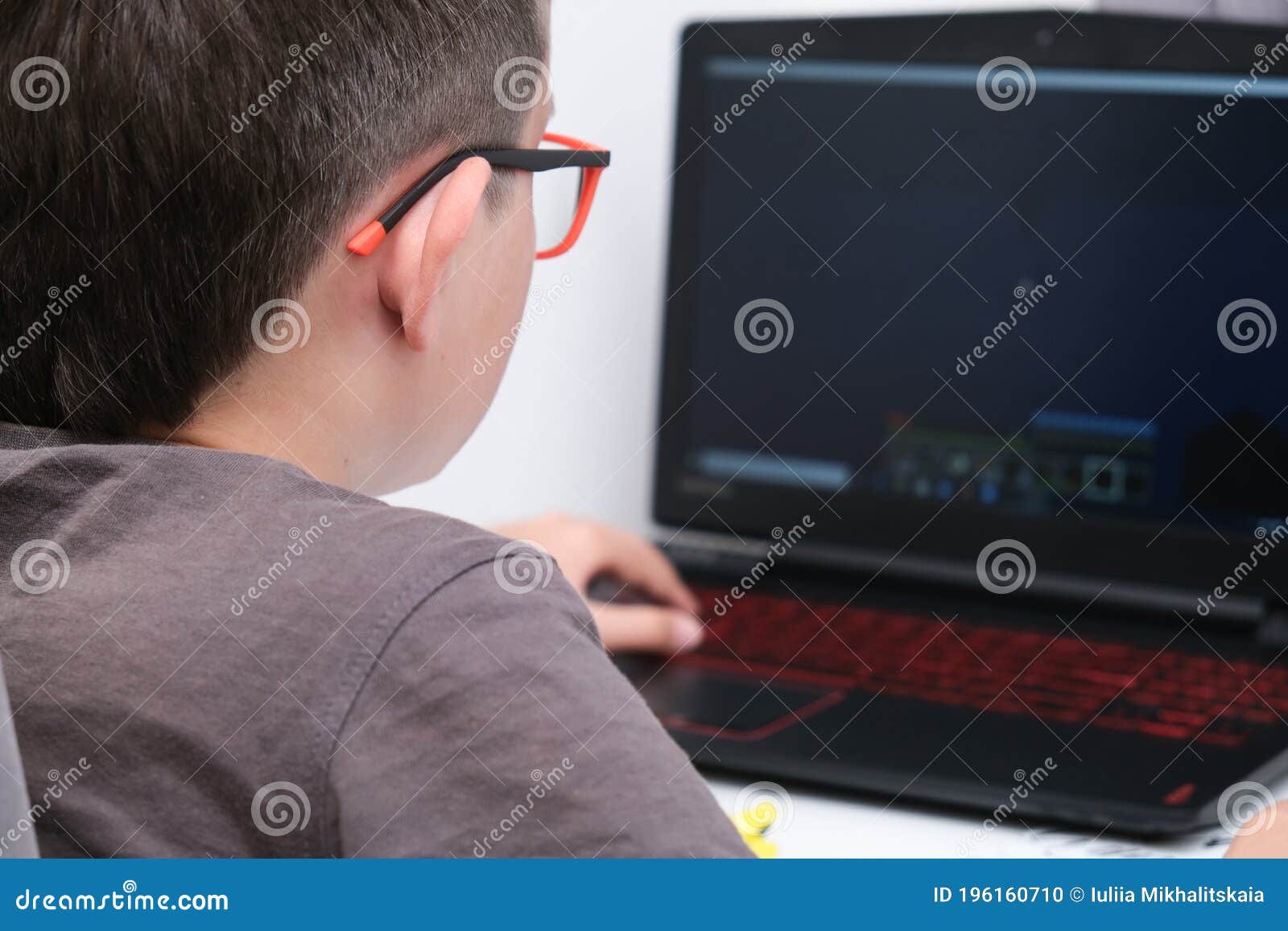 A Boy Playing Online Computer Game, he is Immersed in Atmosphere of ...