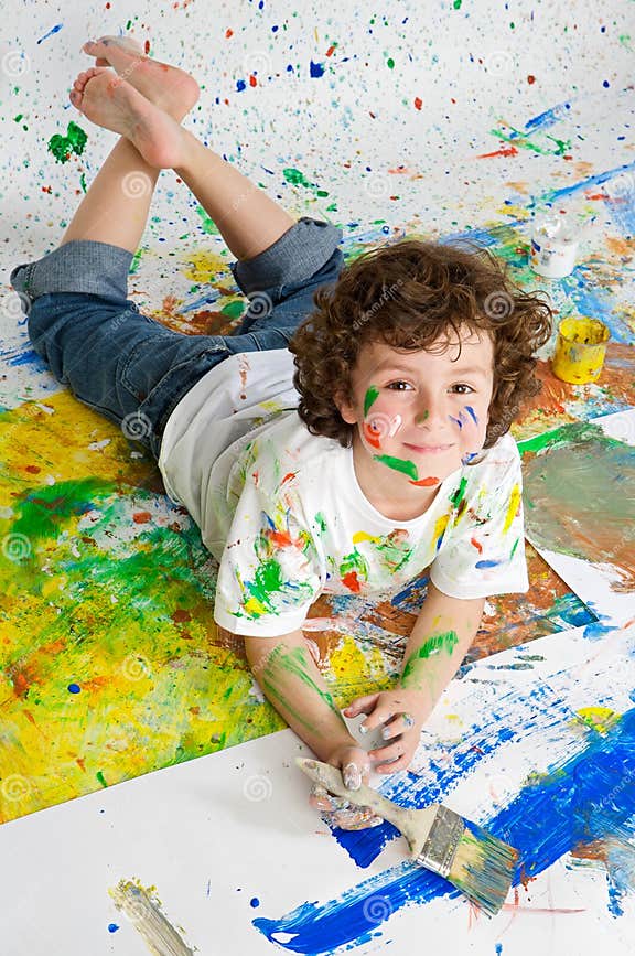 Boy playing with painting stock image. Image of expression - 4854853