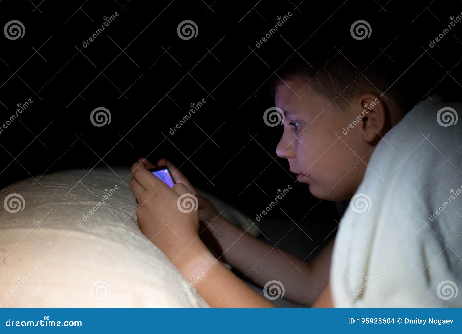 Boy Playing Phone at Night in the Dark, Lying in Bed Stock Photo ...