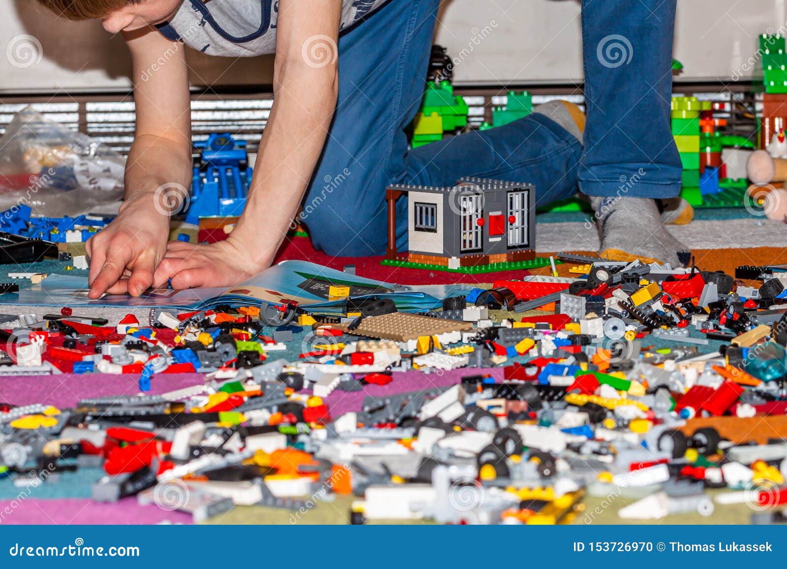 Boy Playing with Plastic Construction Toys on the Floor. Stock Photo ...