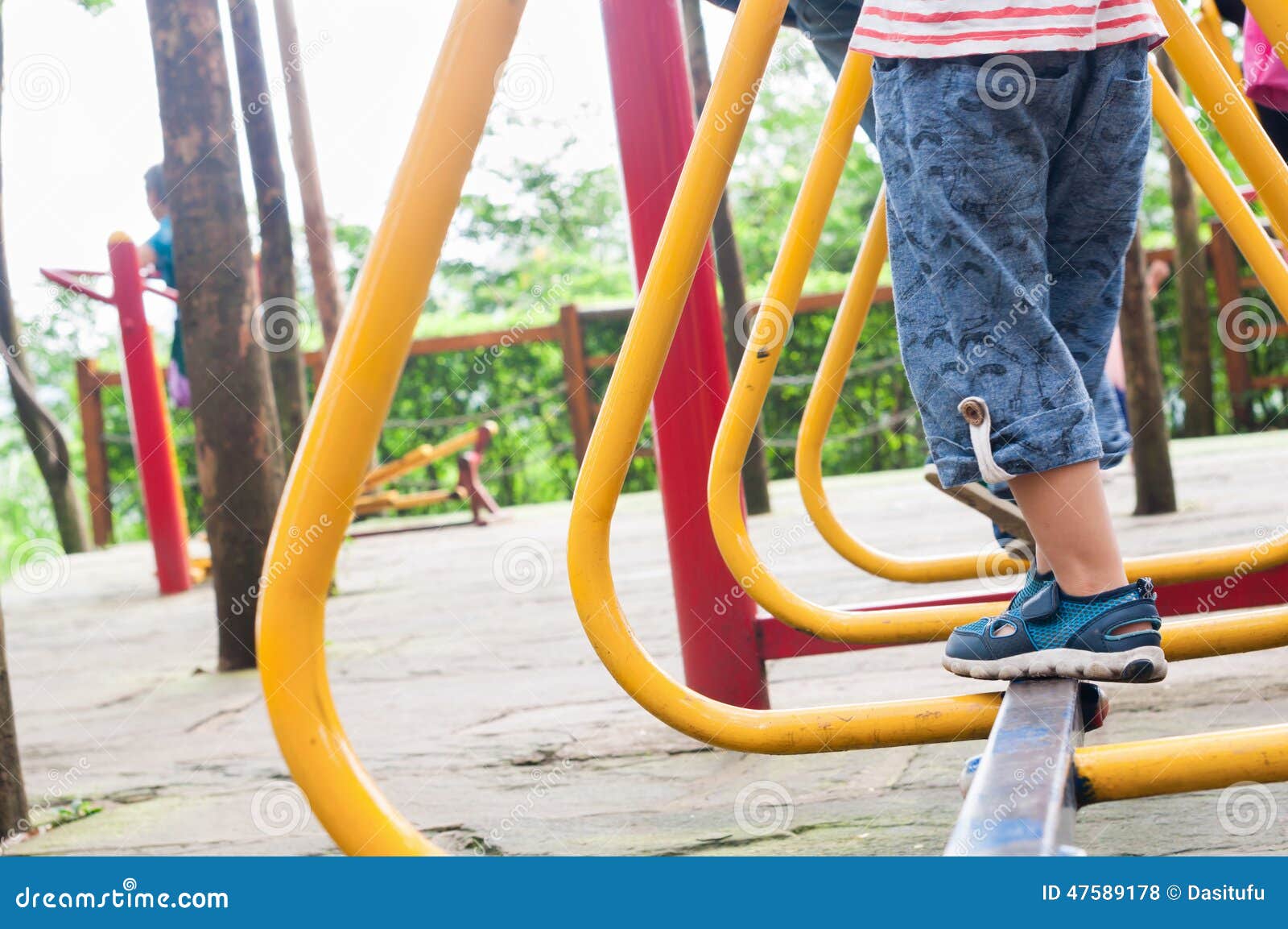 Boy playing on playground stock photo. Image of feet - 47589178