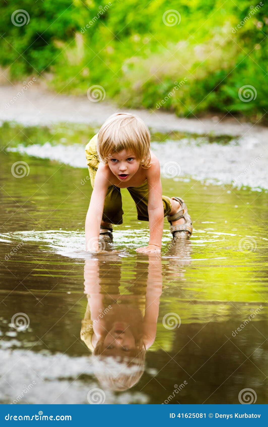 Boy playing in puddle stock image. Image of playful, action - 41625081