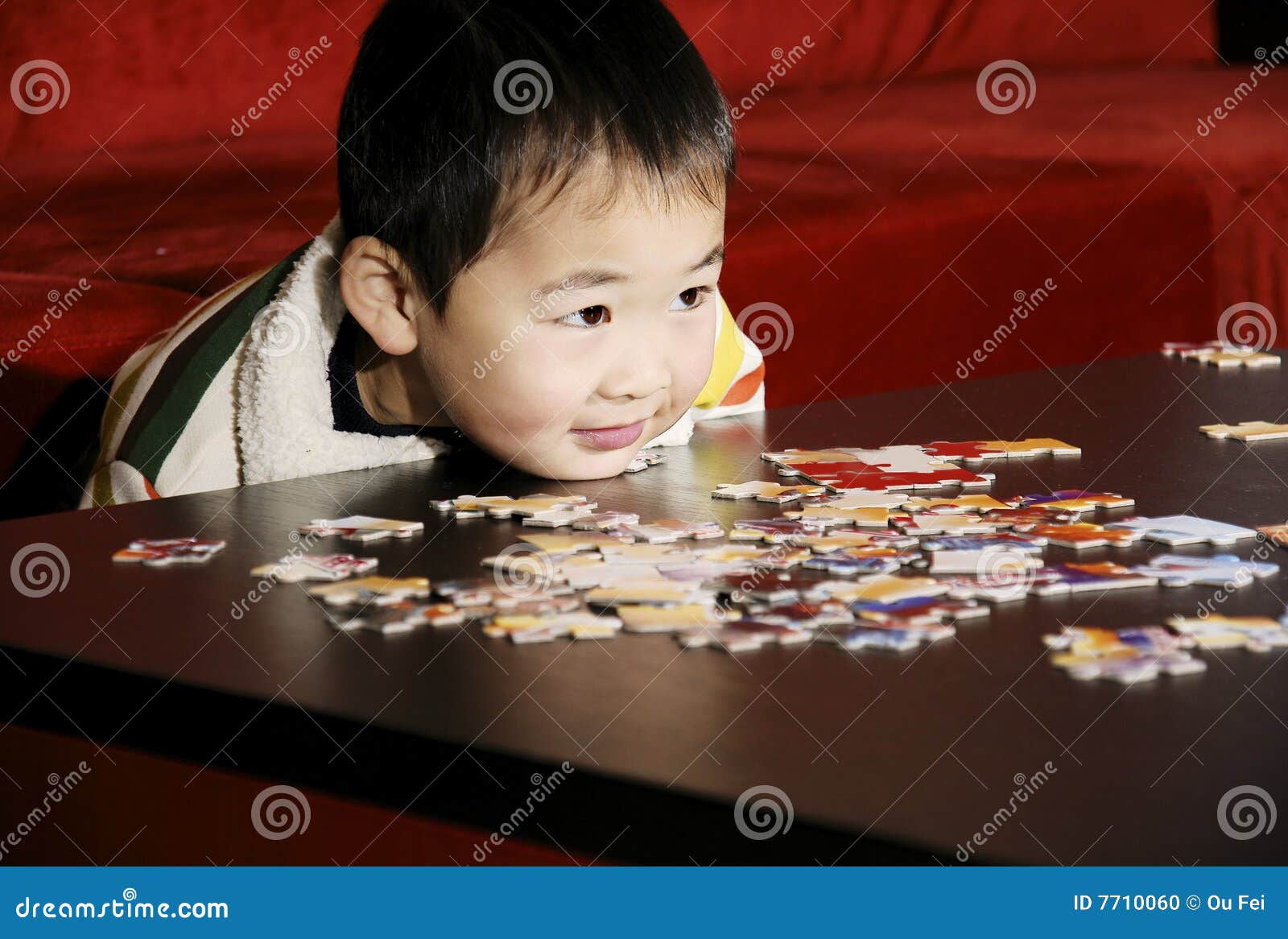 Boy playing puzzle game stock photo. Image of face, play - 7710060