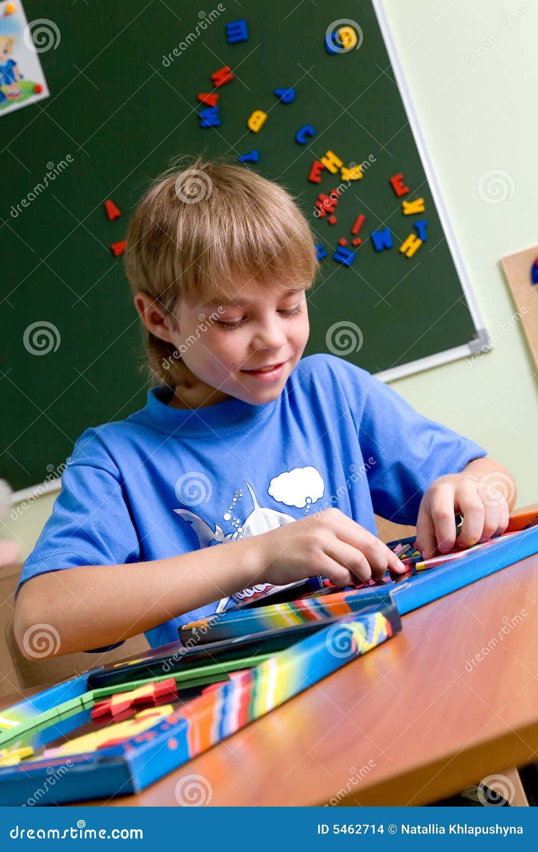 Boy playing with puzzles stock photo. Image of casual - 5462714