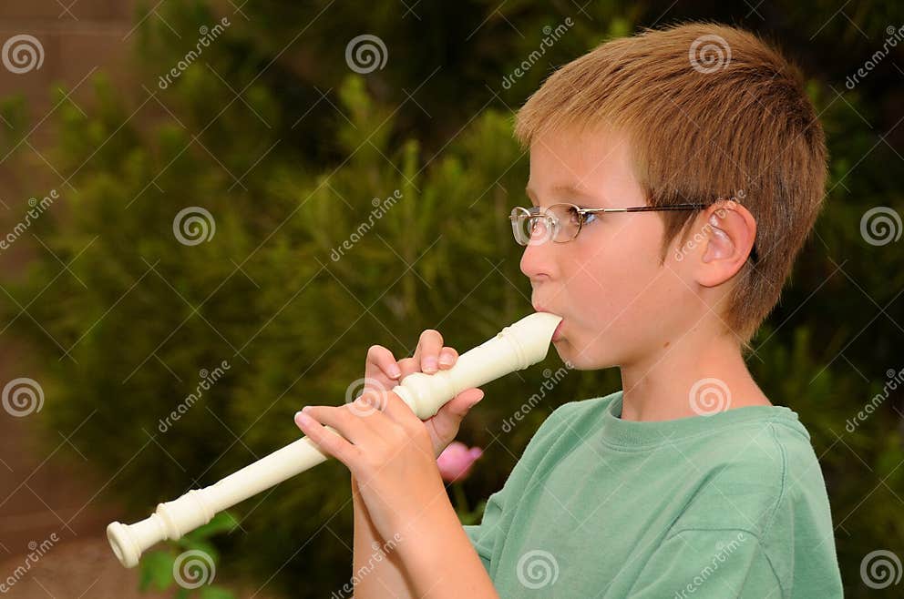 Boy playing a recorder stock photo. Image of activity - 9279662