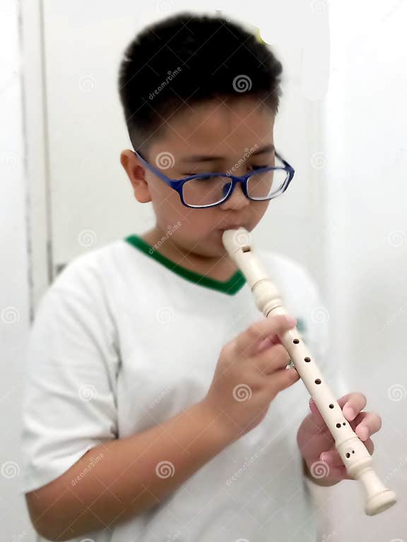 A Boy is Playing the Recorder Stock Image - Image of hairstyle ...