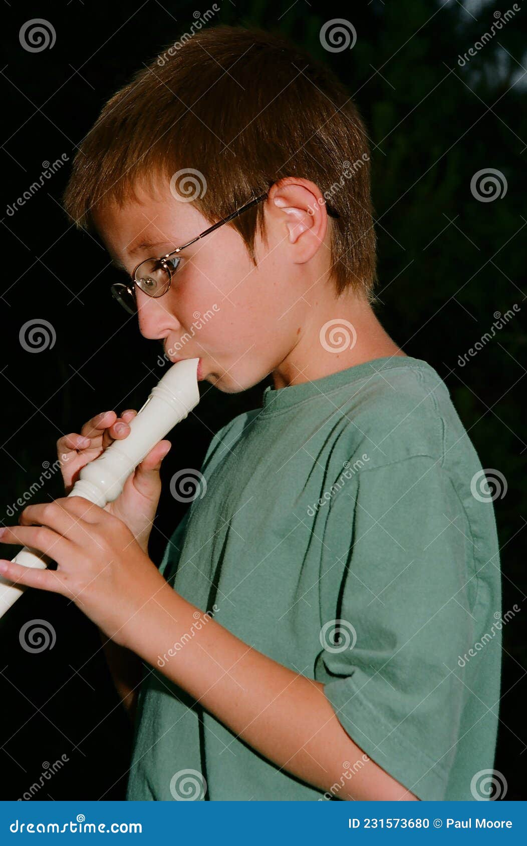 Boy playing a recorder stock photo. Image of playing - 231573680