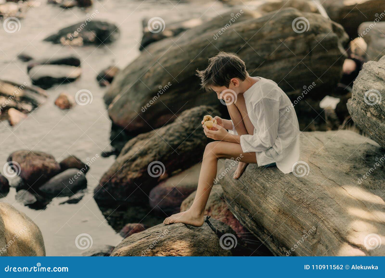 The Boy is Playing on Rocks Stock Photo - Image of coastal, beautiful ...