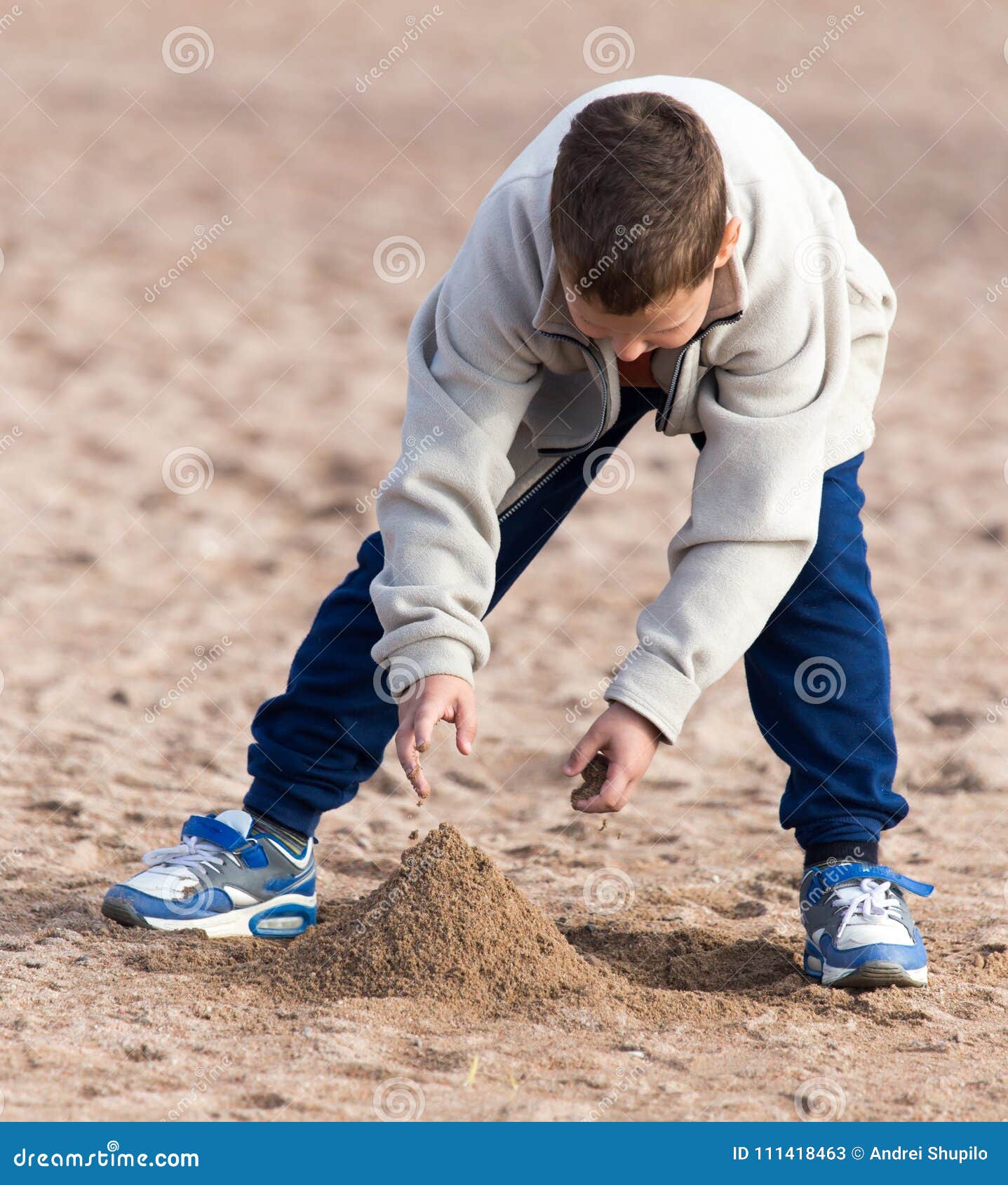 Boy playing in the sand stock image. Image of playing - 111418463
