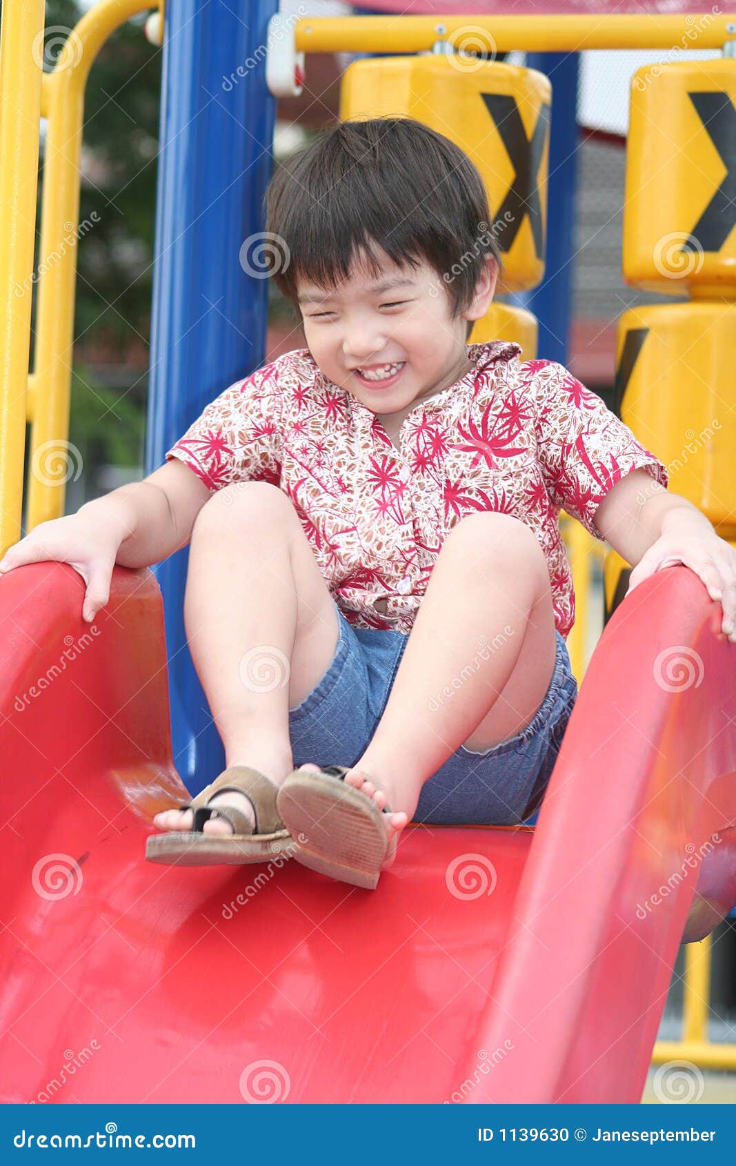 Boy playing on slide stock photo. Image of expression - 1139630