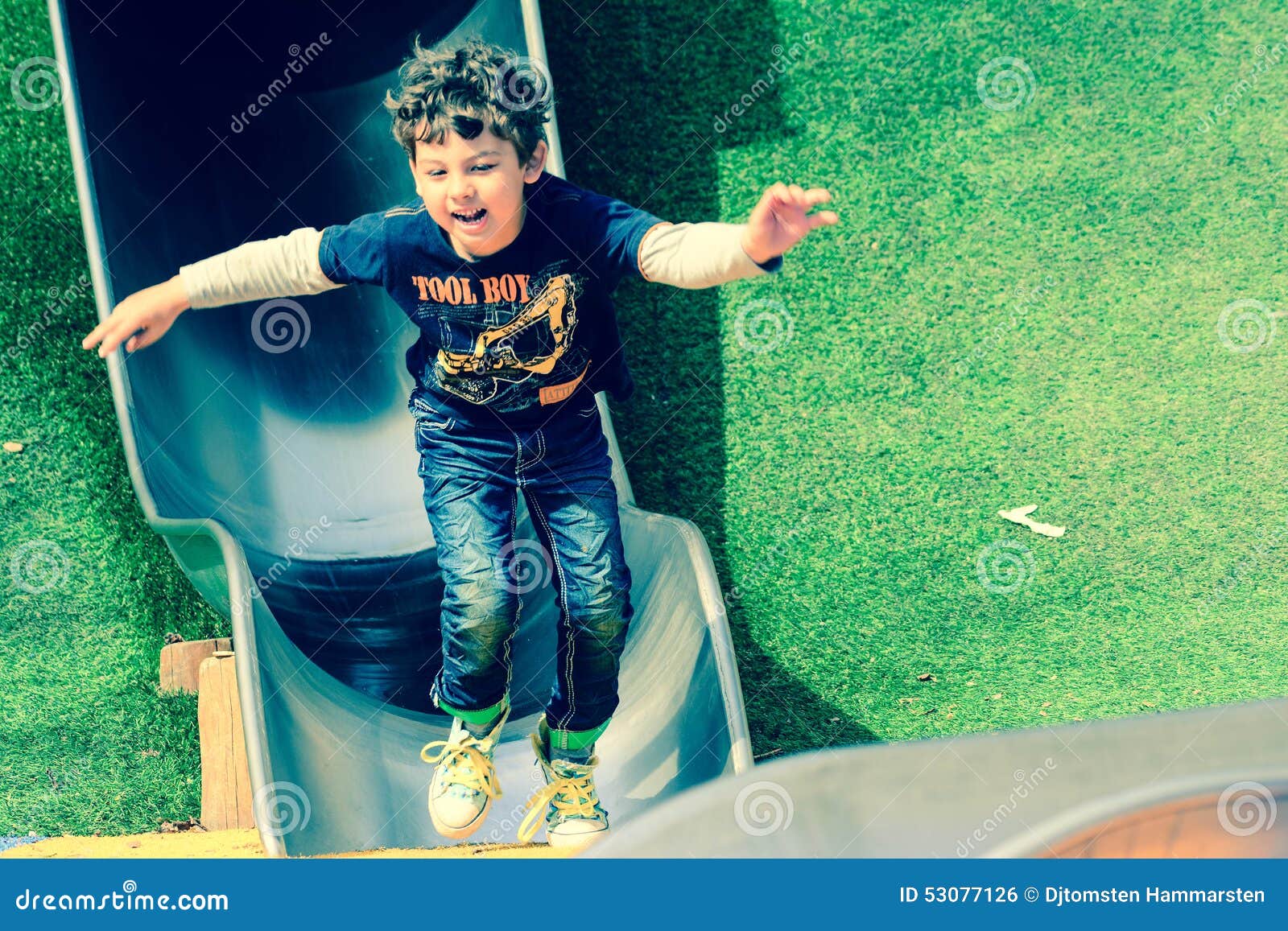 Boy playing on the slide stock photo. Image of park, african - 53077126