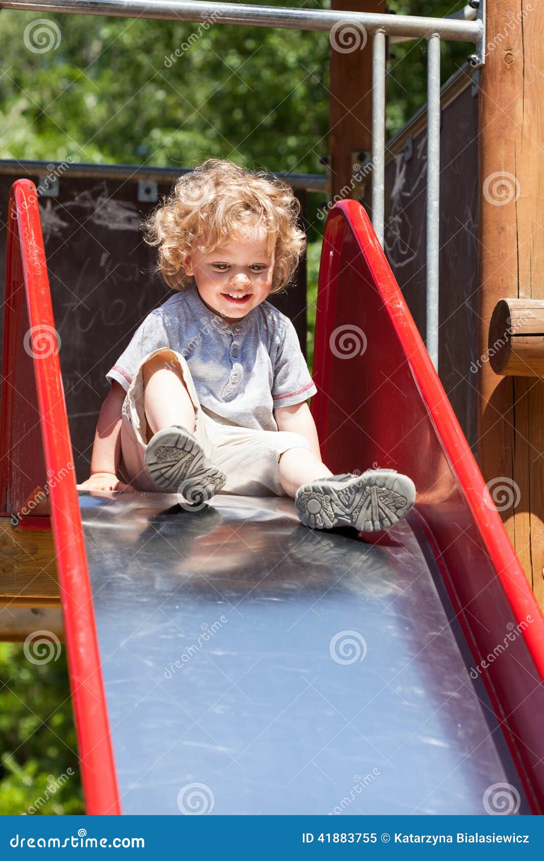 Boy playing on slide stock image. Image of childhood - 41883755