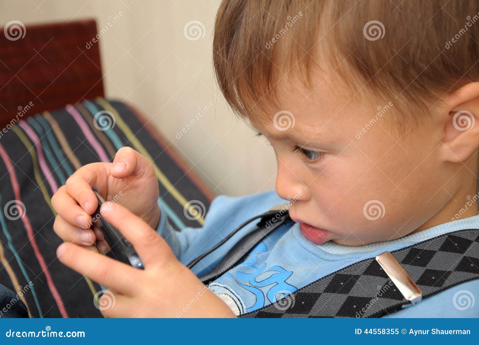Boy playing on smartphone stock image. Image of finger - 44558355