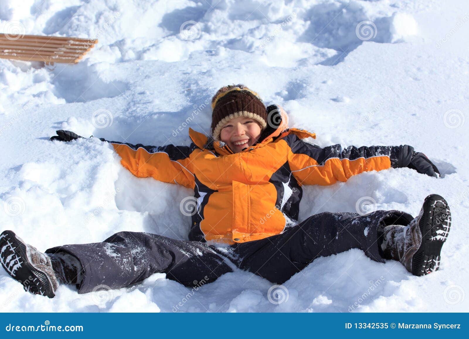 Boy playing in snow stock image. Image of playful, snowy - 13342535