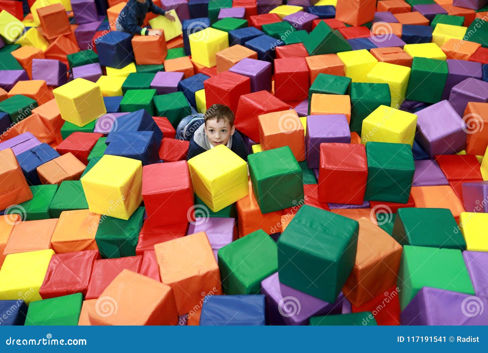 Boy playing at soft cubes stock image. Image of colorful - 117191541