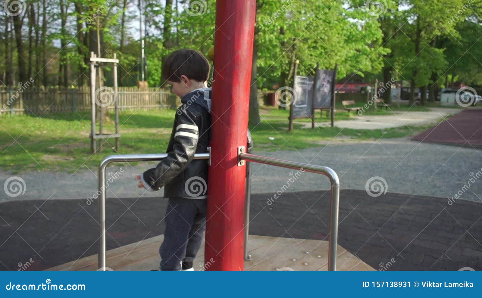 A Boy is Playing, Spinning on a Ride on a Playground Stock Video ...