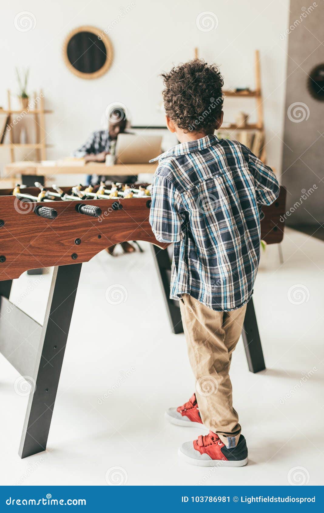 Boy playing table football stock image. Image of family - 103786981