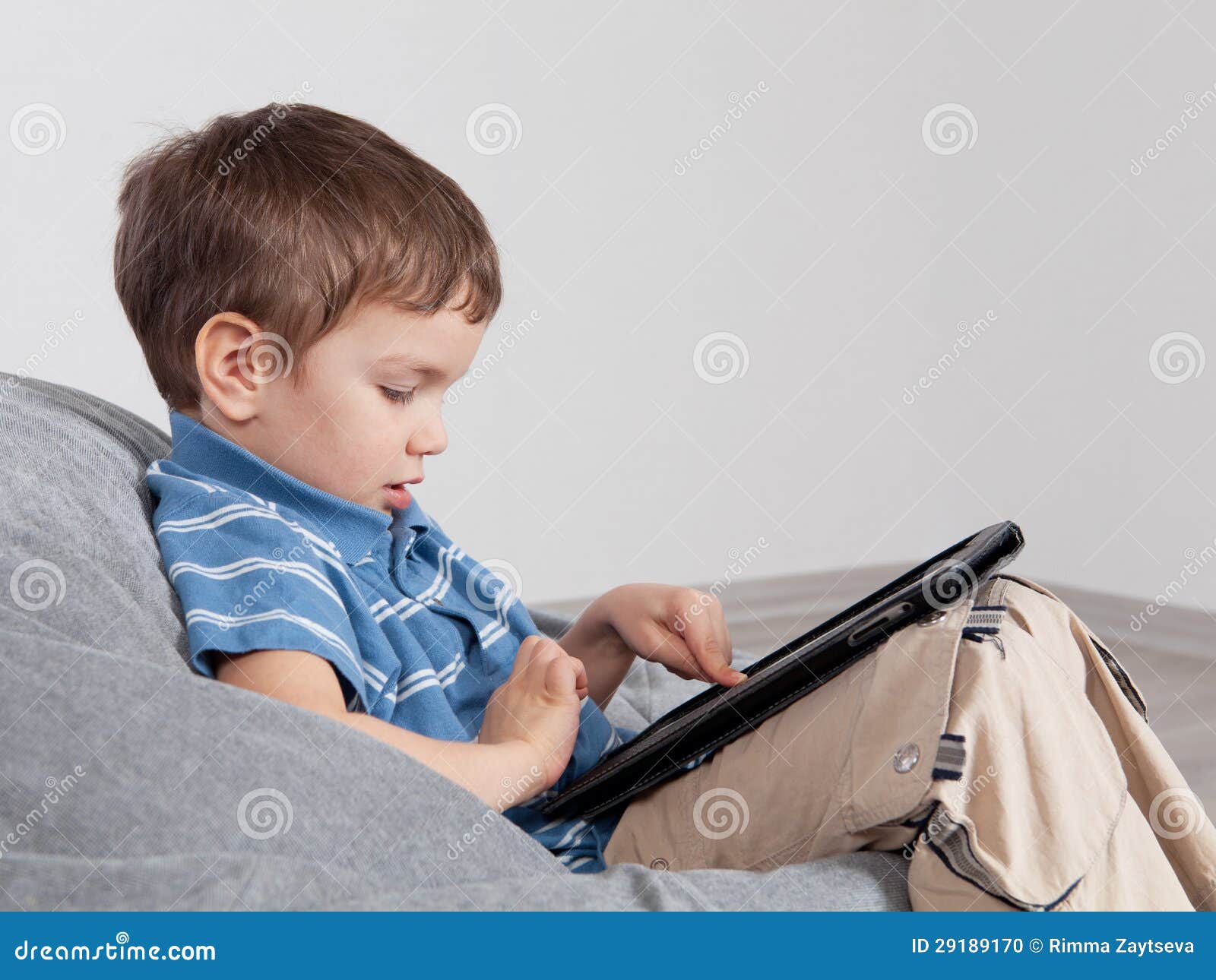 Boy playing on tablet stock photo. Image of notebook - 29189170