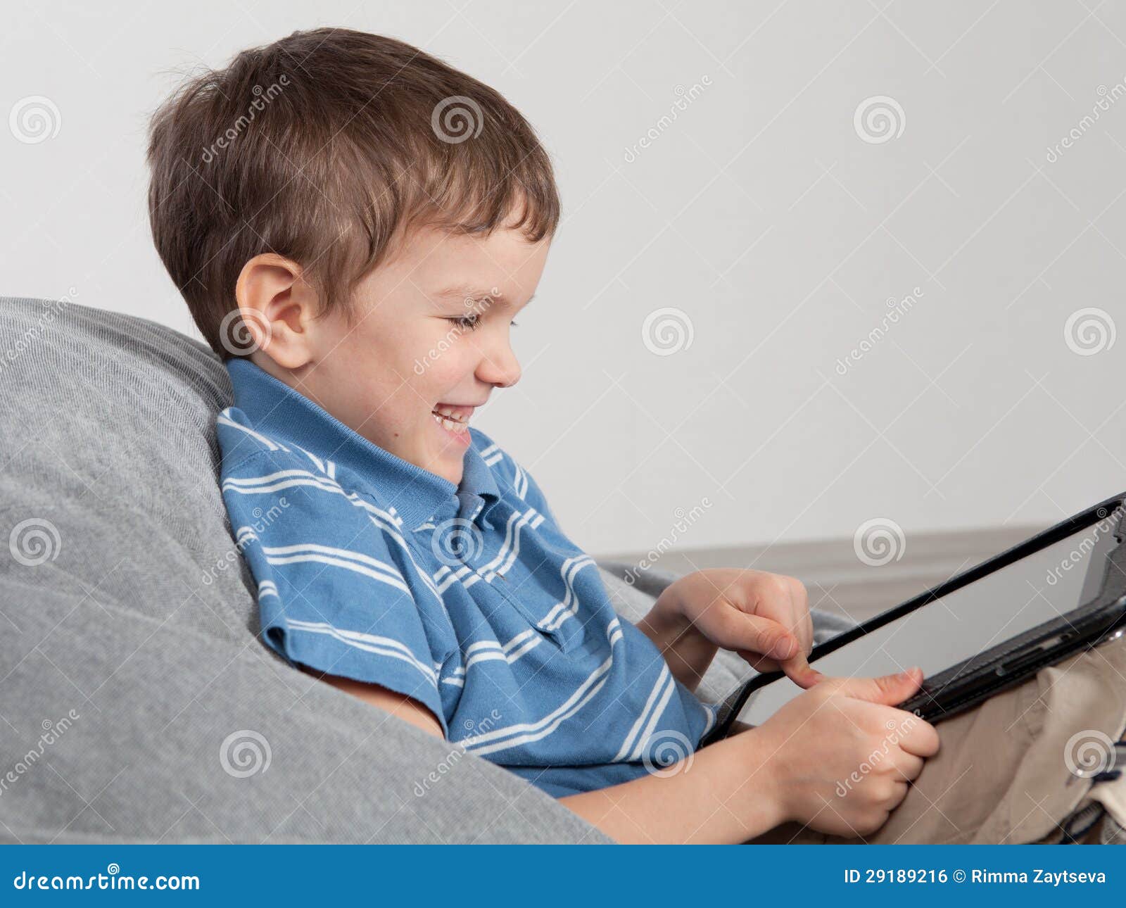 Boy playing on tablet stock photo. Image of touchscreen - 29189216