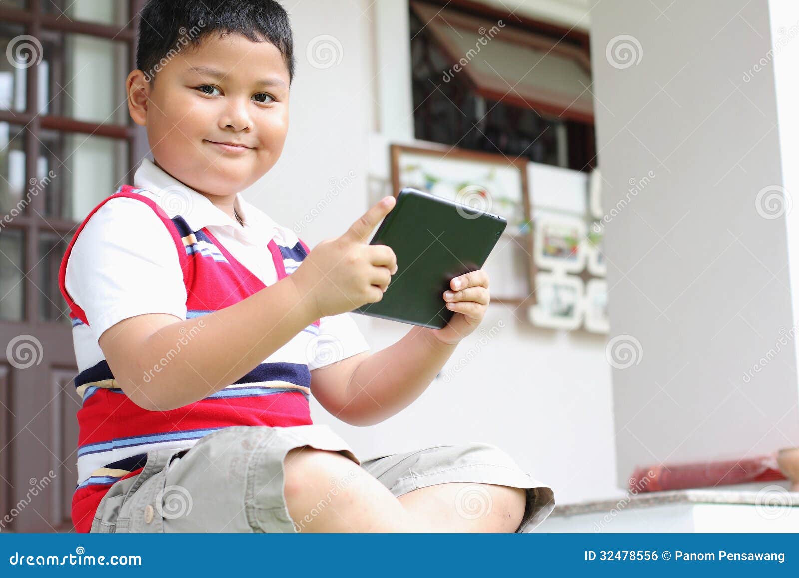 Boy playing Tablet fun. stock photo. Image of indoors - 32478556