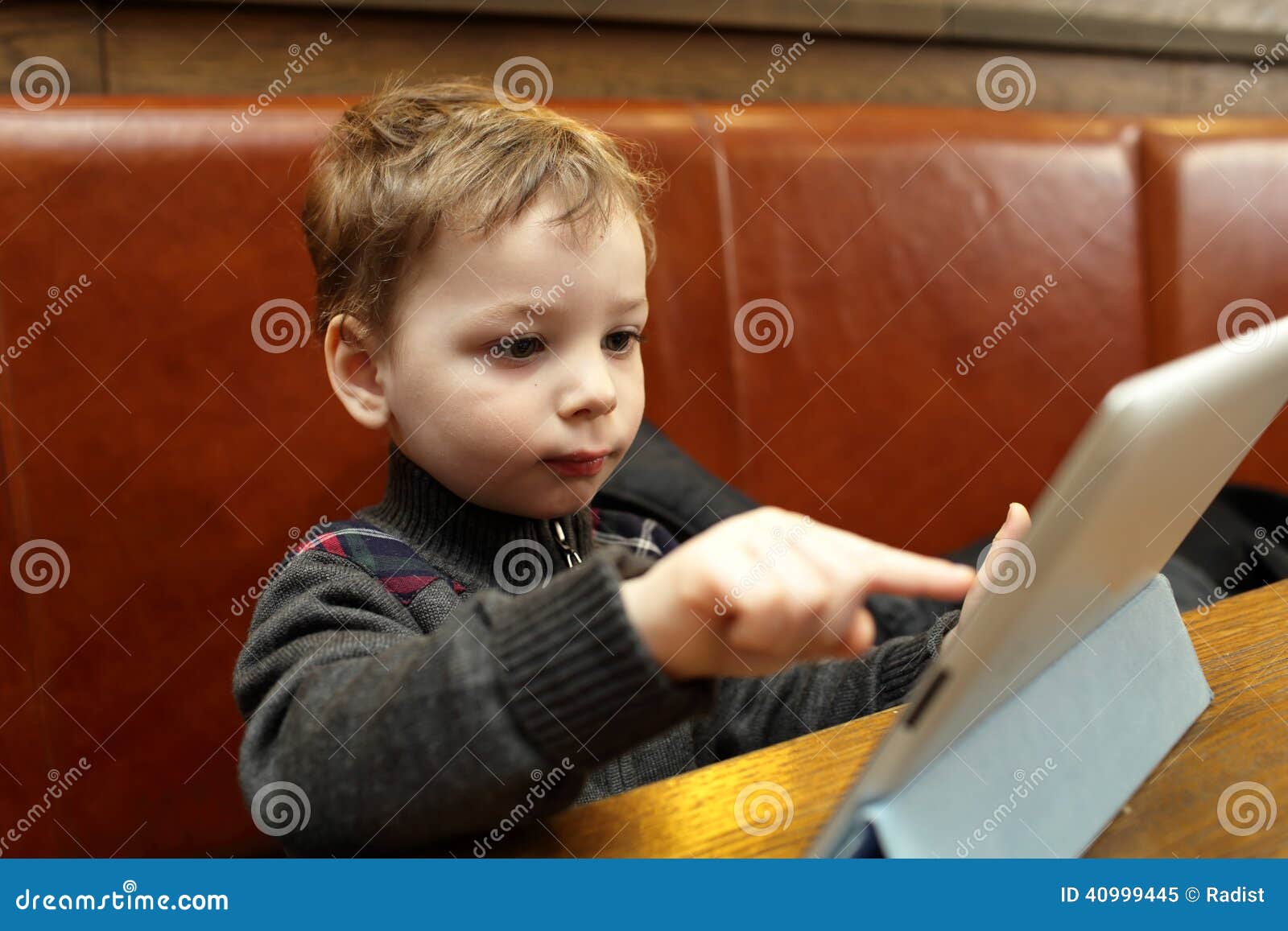Boy playing on a Tablet PC stock image. Image of concentration - 40999445