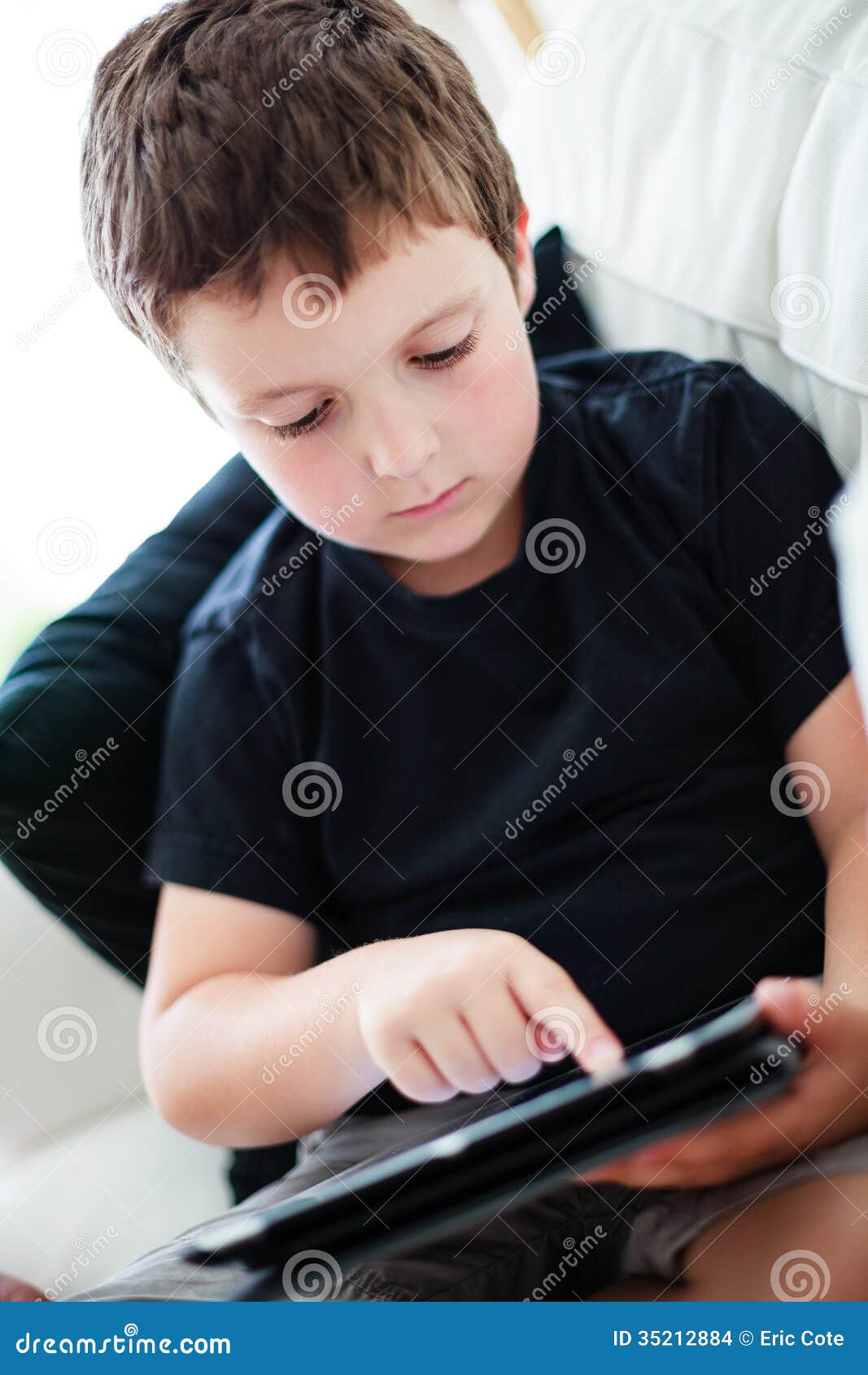 Boy playing on a tablet stock photo. Image of sitting - 35212884
