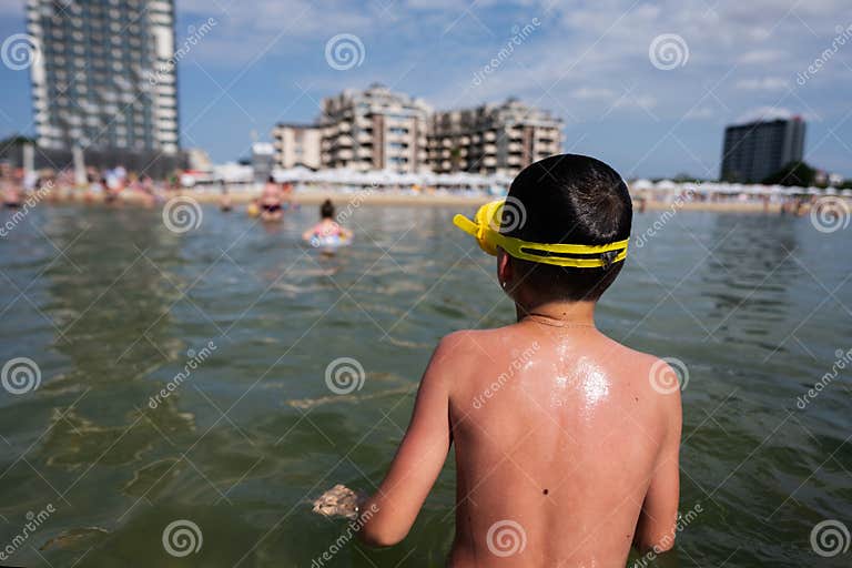 Boy Playing in the Water on the Beach Stock Image - Image of activity ...